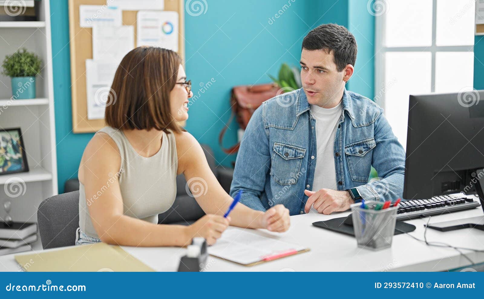 Two Workers Man and Woman Sitting on Table Working and Speaking at the ...