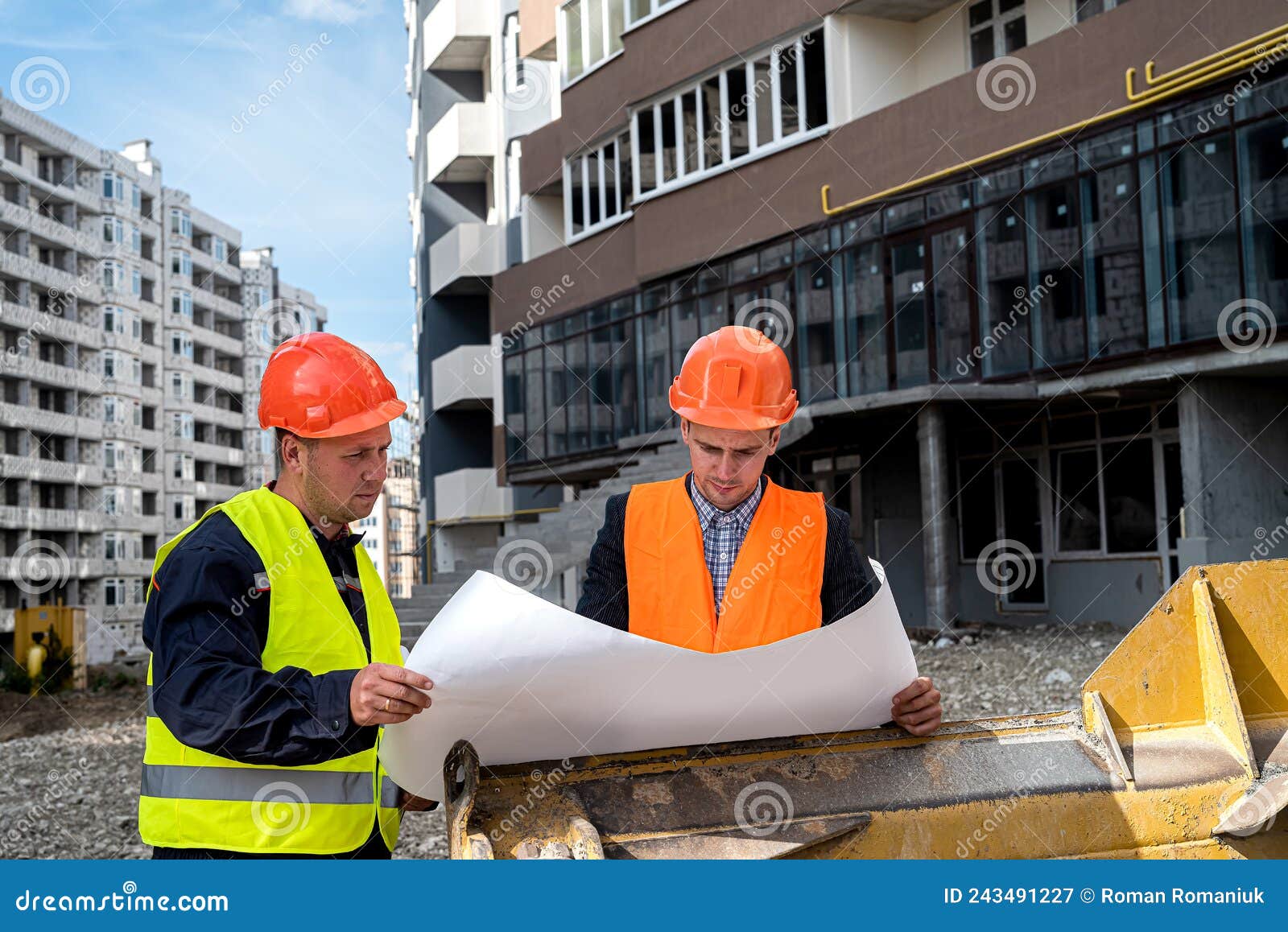 Two Workers in Overalls and Helmets Developed a Construction Plan for ...