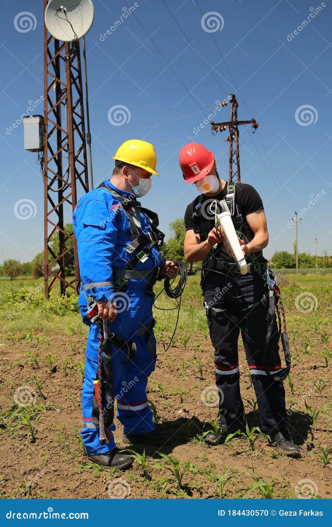 Two Workers with Protective Equipment and Covid 19 Masks Install a ...