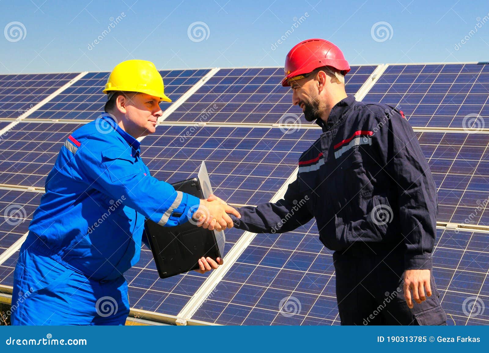 Two Workers Shake Hands in Front of the Solar Power Plant Stock Image ...