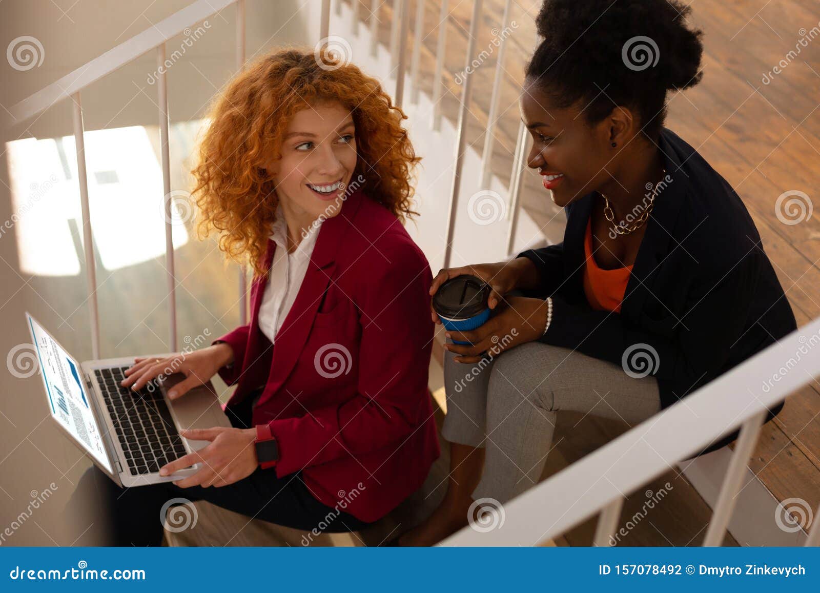 Two Workers Sitting on Stairs while Working on Laptop Stock Photo ...