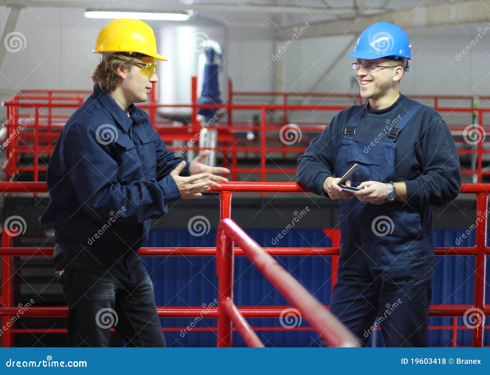 Two Workers Talking in a Factory Stock Photo - Image of equipment ...