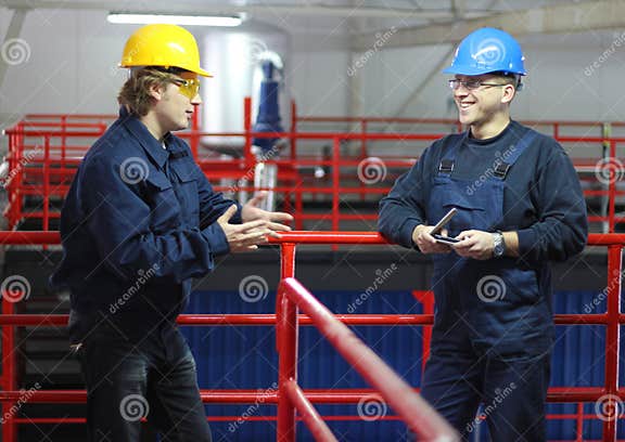 Two Workers Talking in a Factory Stock Photo - Image of equipment ...