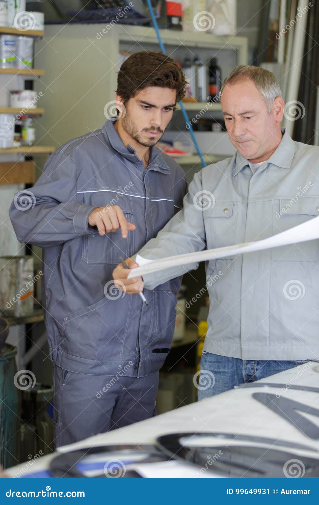 Two Workers Talking while Holding Papers and Ruler Stock Image - Image ...