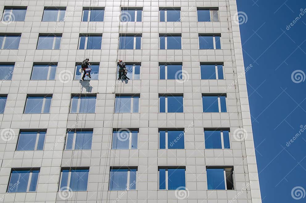 Two Workers Wash the Windows on a High-rise Building Stock Image ...