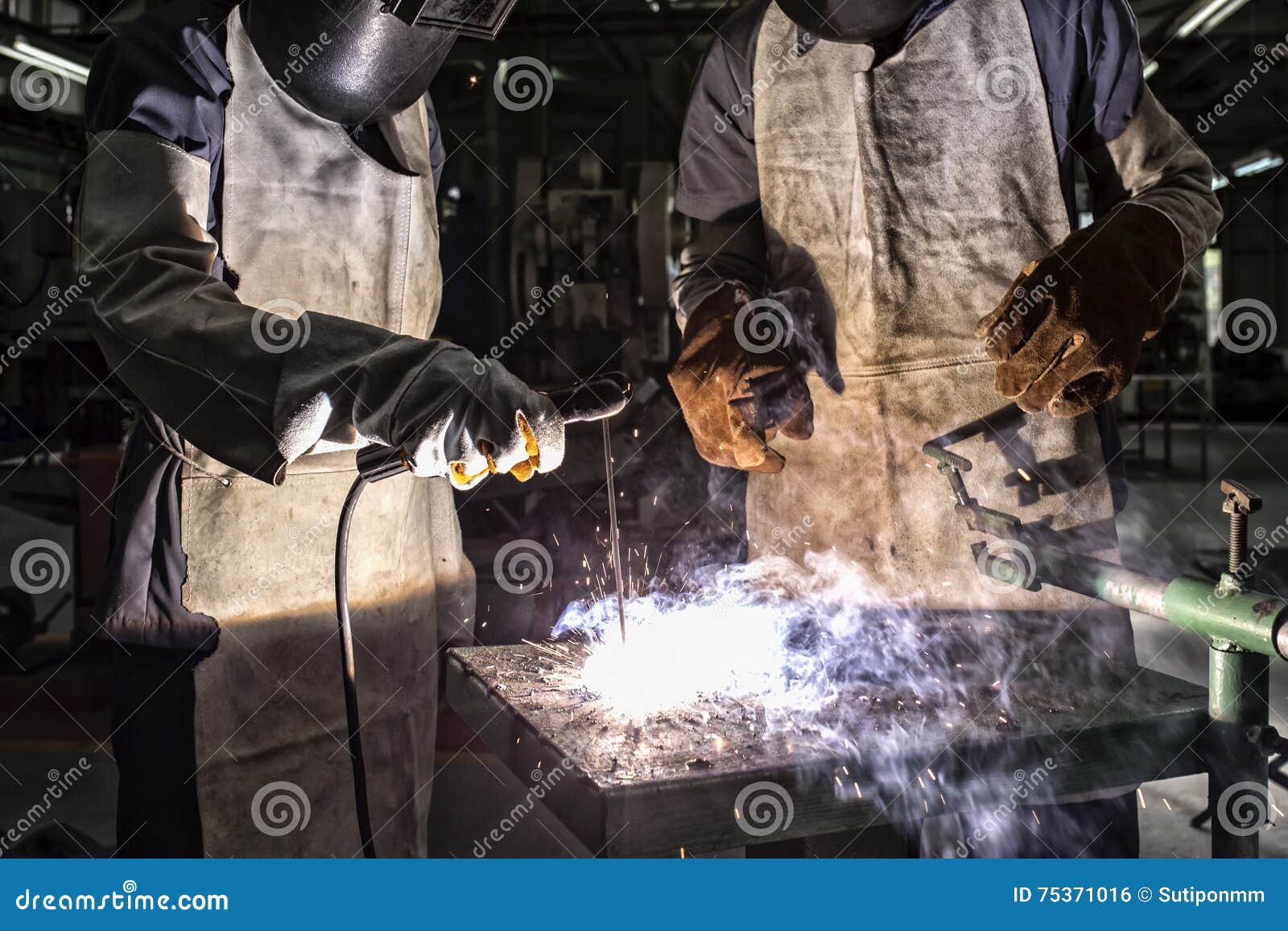 Two workers Welding steel stock photo. Image of metal - 75371016