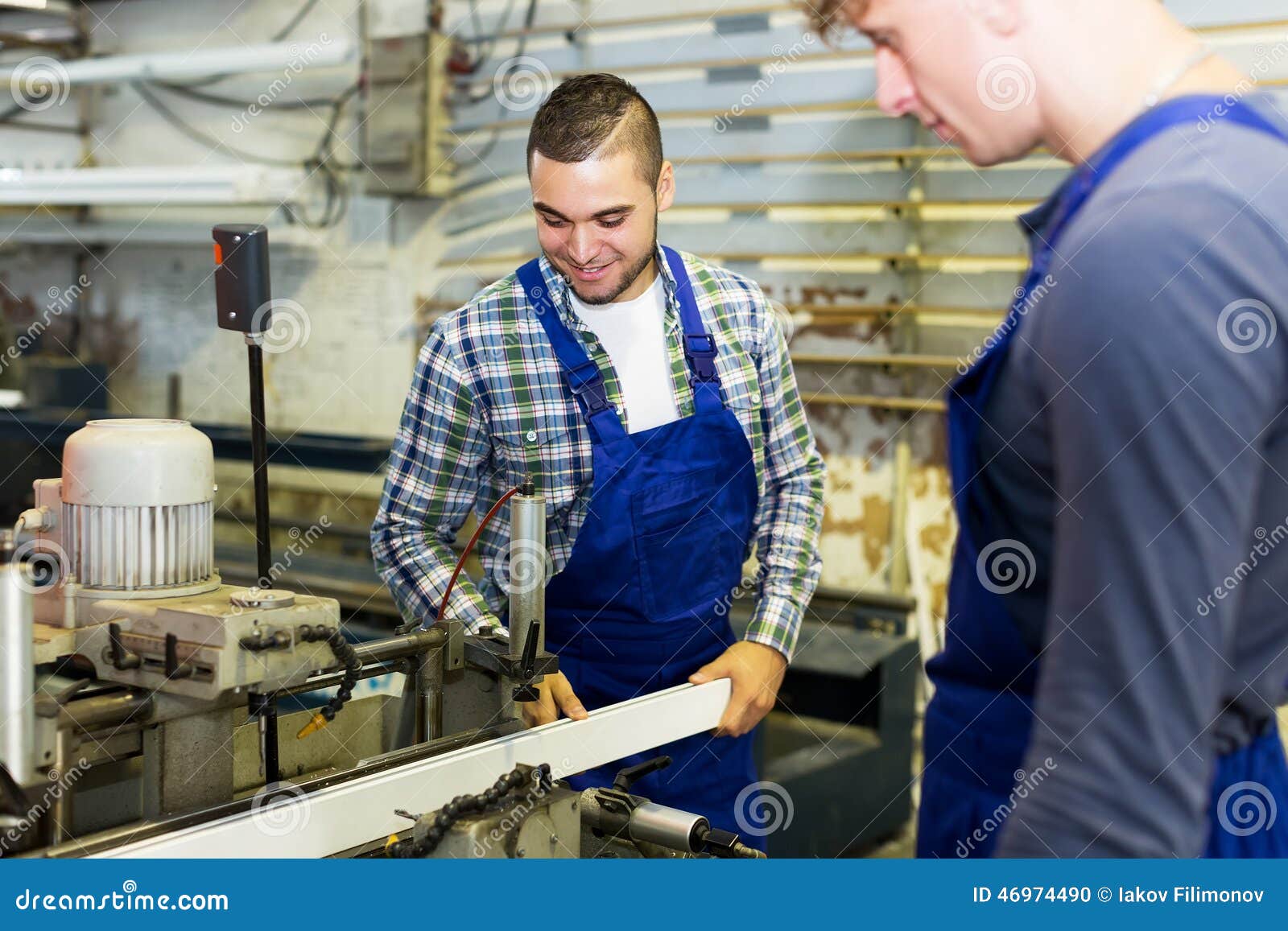 Two Workers Working on a Machine Stock Photo - Image of smiling ...