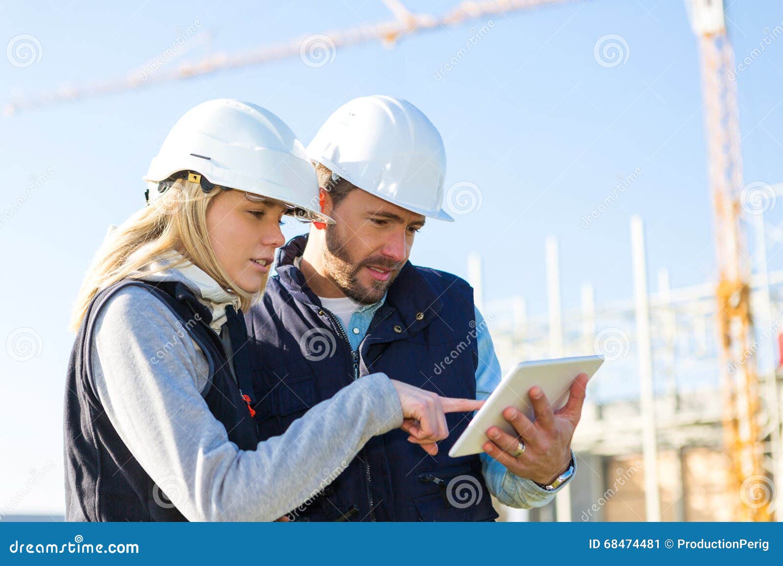 Two Workers Working Outside with a Tablet on a Construction Site Stock ...