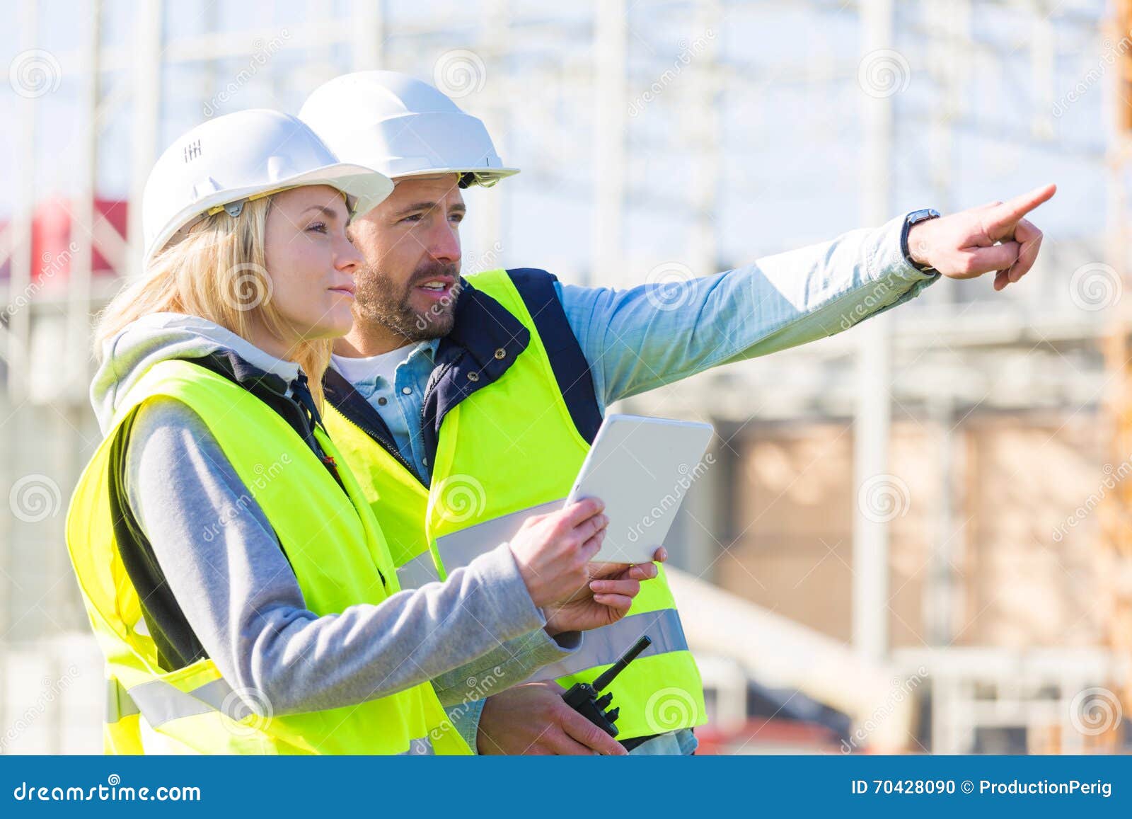 Two Workers Working Outside with a Tablet on a Construction Site Stock ...