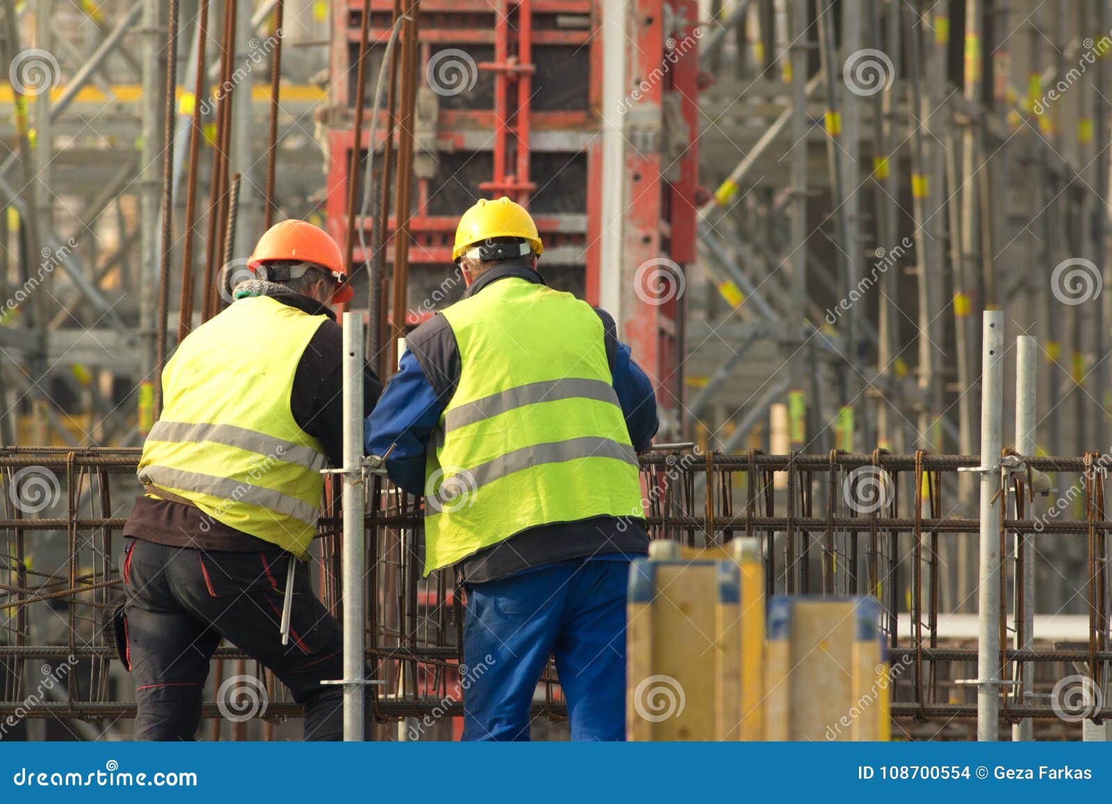 Two Labours in Yellow at the Construction Site Stock Photo - Image of ...