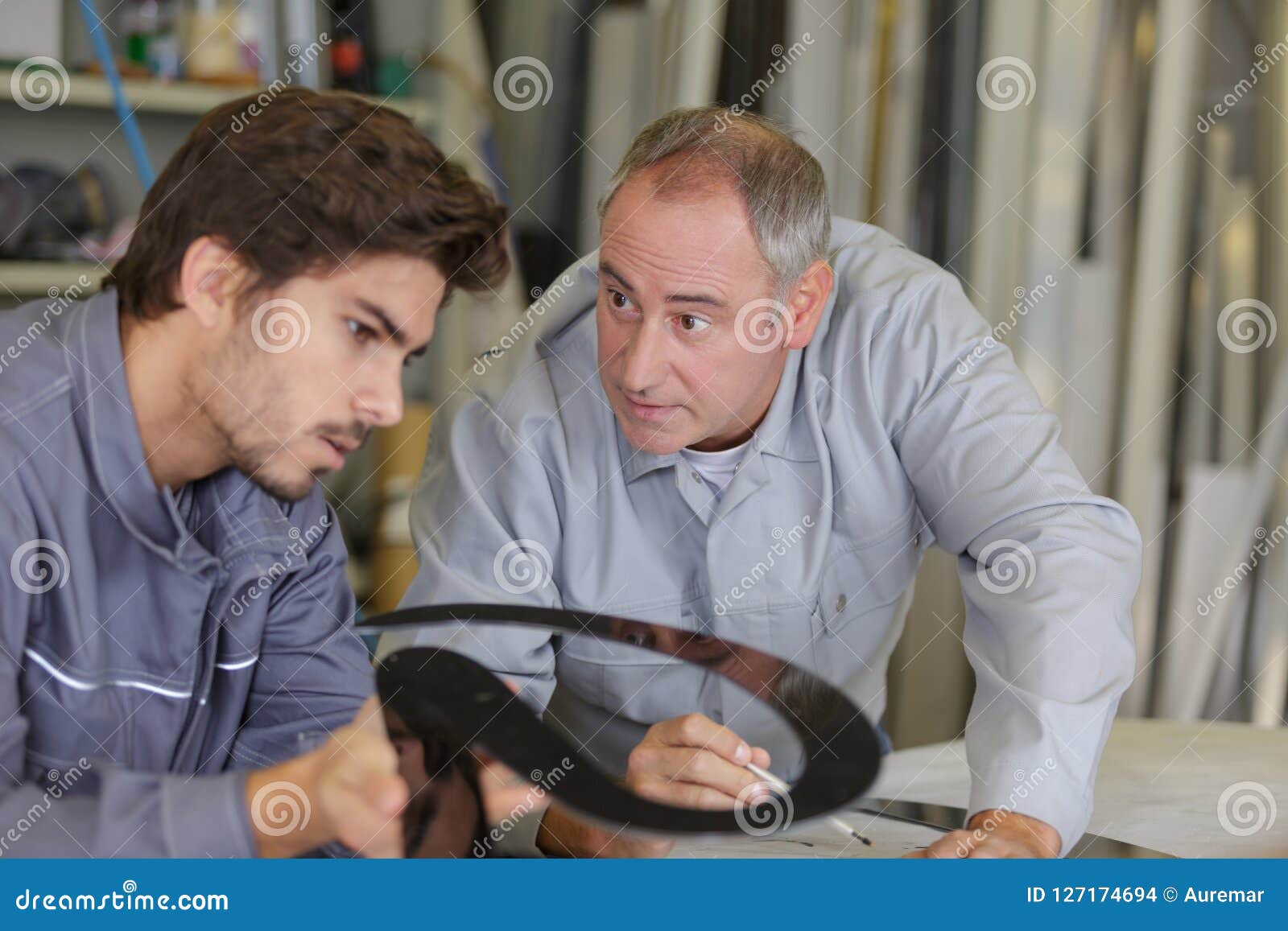 Two Workmen Conferring Over Paperwork Stock Photo - Image of serious ...
