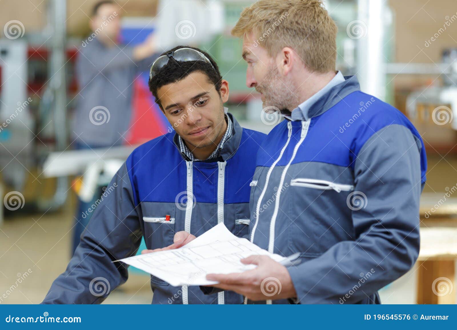 Two workmen at factory stock photo. Image of paper, plan - 196545576