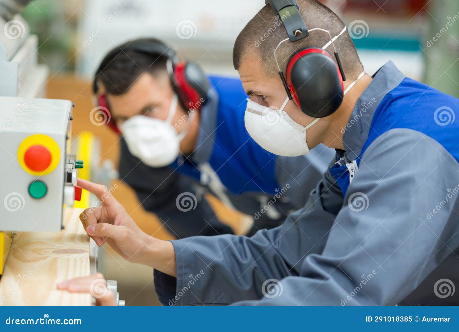 Two Workmen Operating Machines Stock Image - Image of back, mature ...