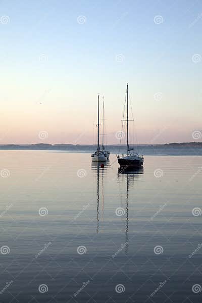 Two yachts lined up stock photo. Image of piers, sunset - 20675826