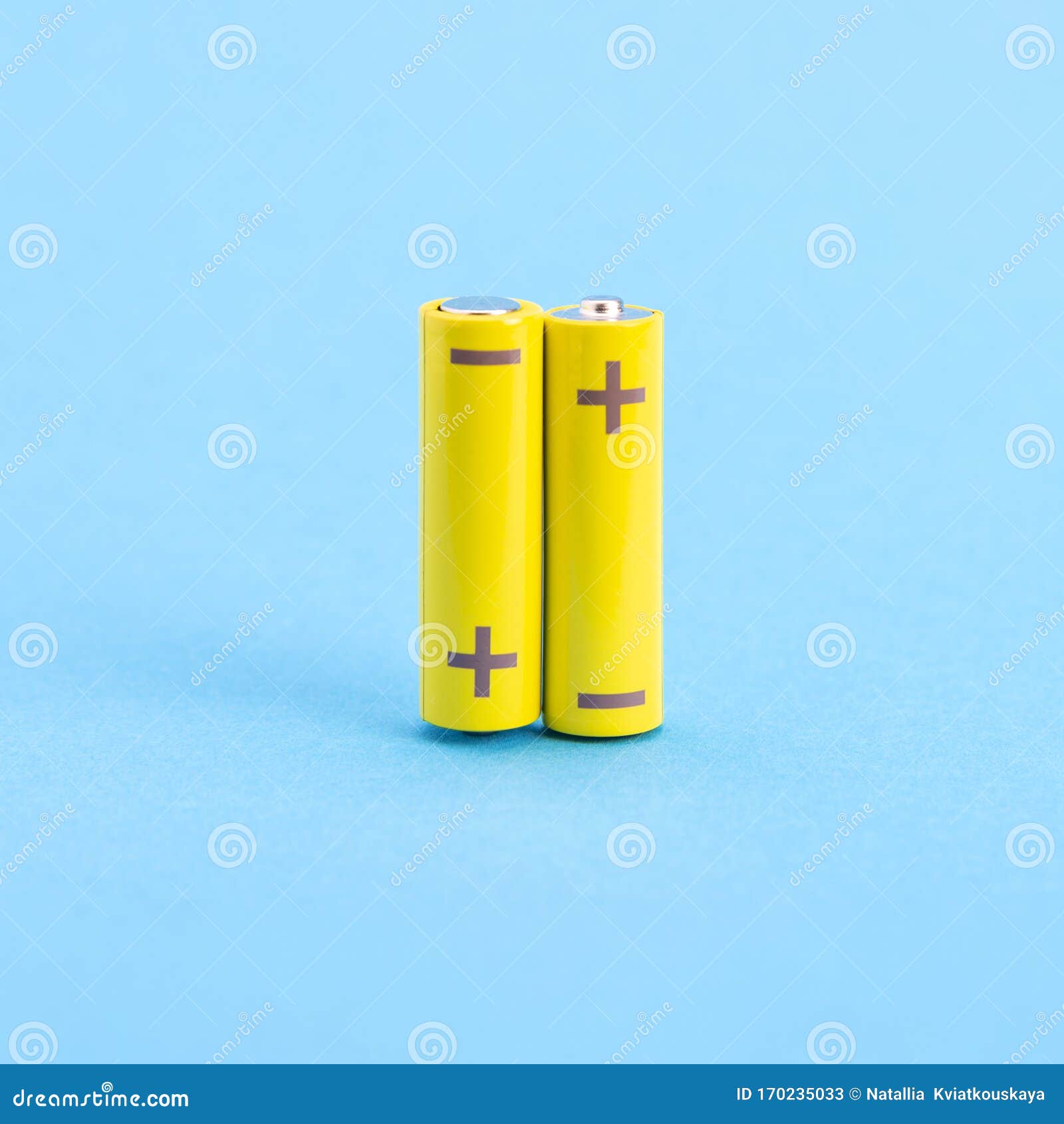 Two Yellow Batteries on a Blue Background Stock Image - Image of close ...