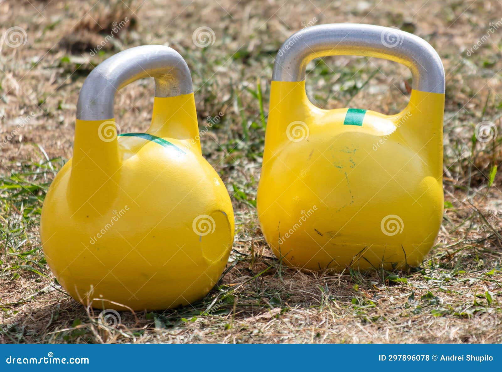 Two Yellow Weights on the Ground in the Park Stock Photo - Image of ...
