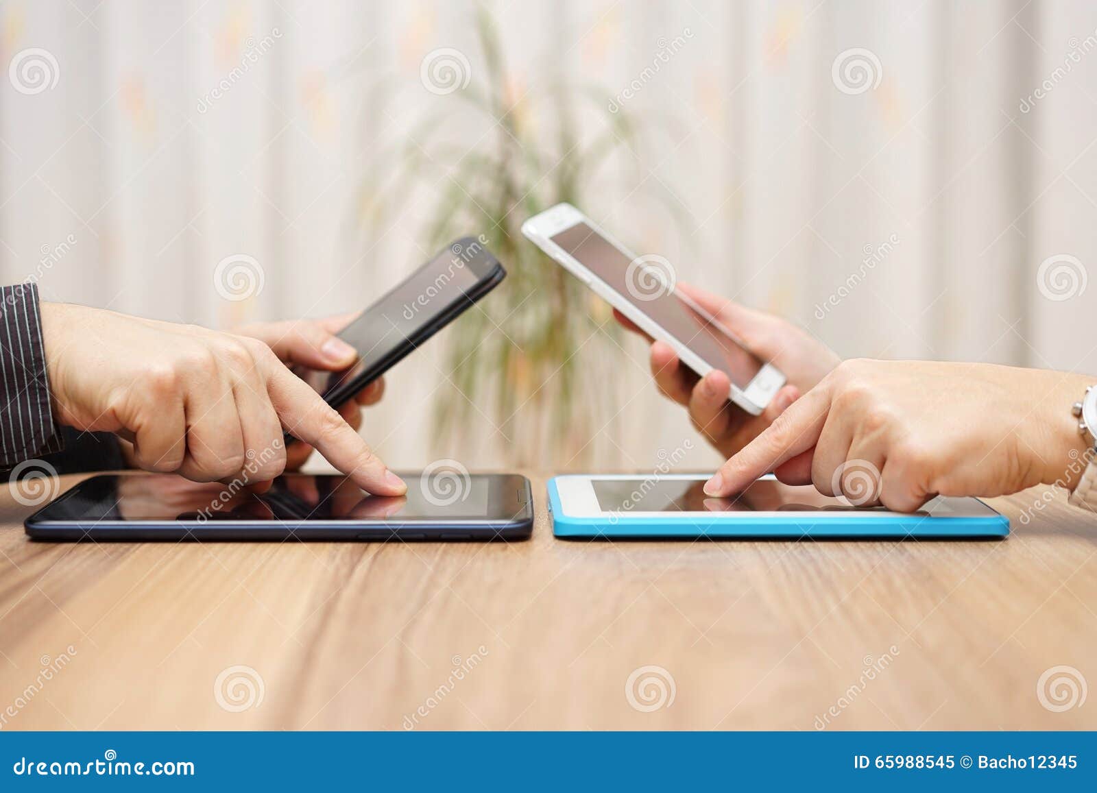 Two Young Adults are Using Multiple Tablets and Phones in Their Stock ...