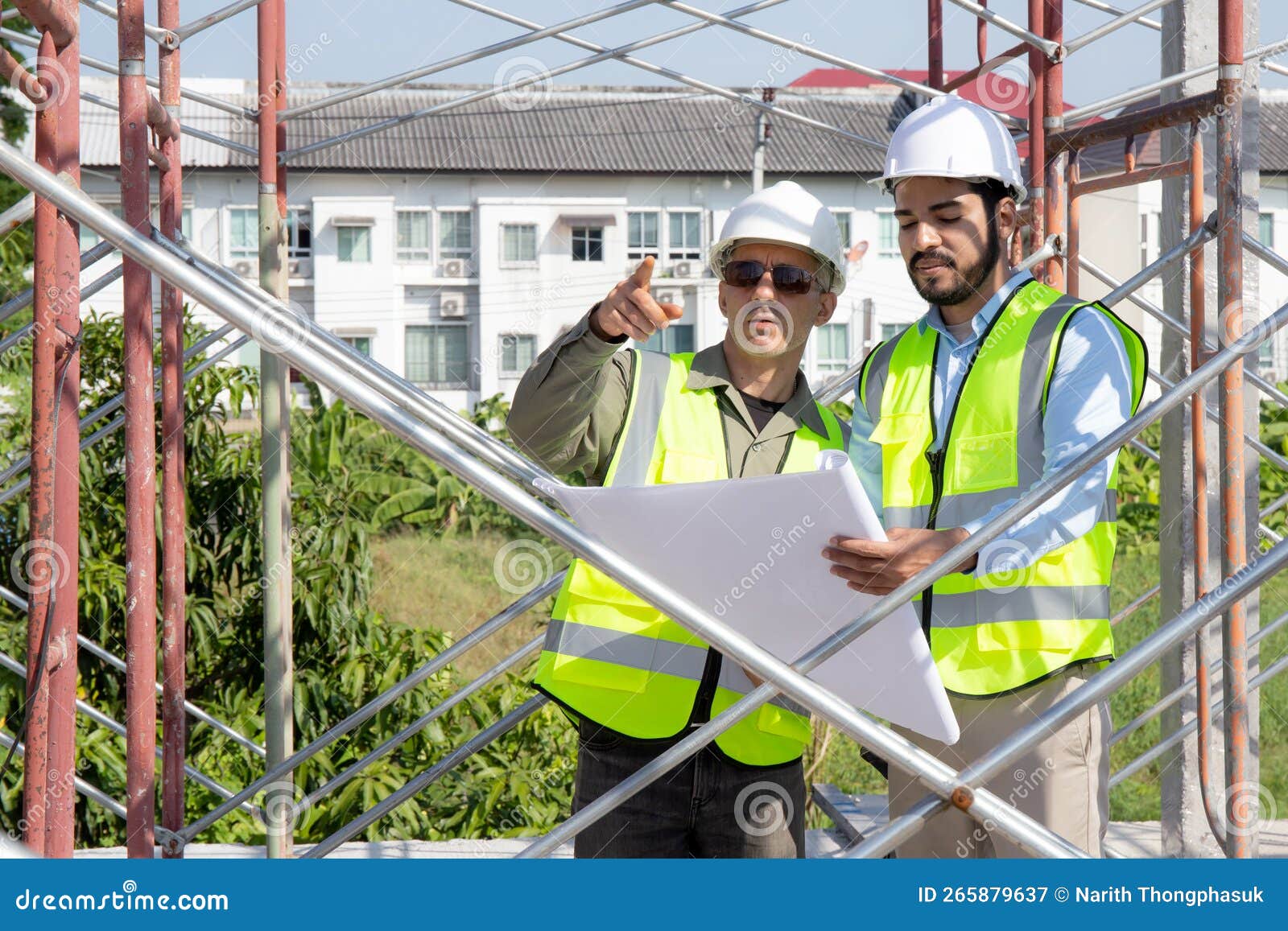 Two Young Architect Discussion or Contractor Man while Looking ...
