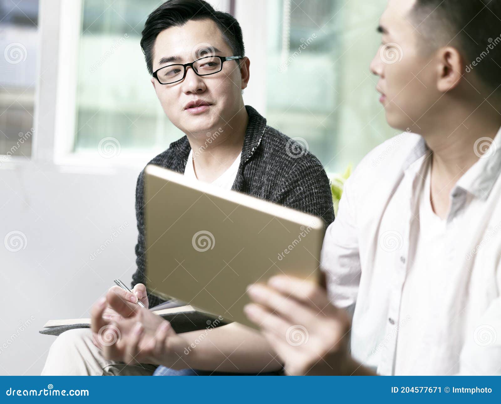 Two Young Asian Men Discussing Business in Office Stock Image - Image ...