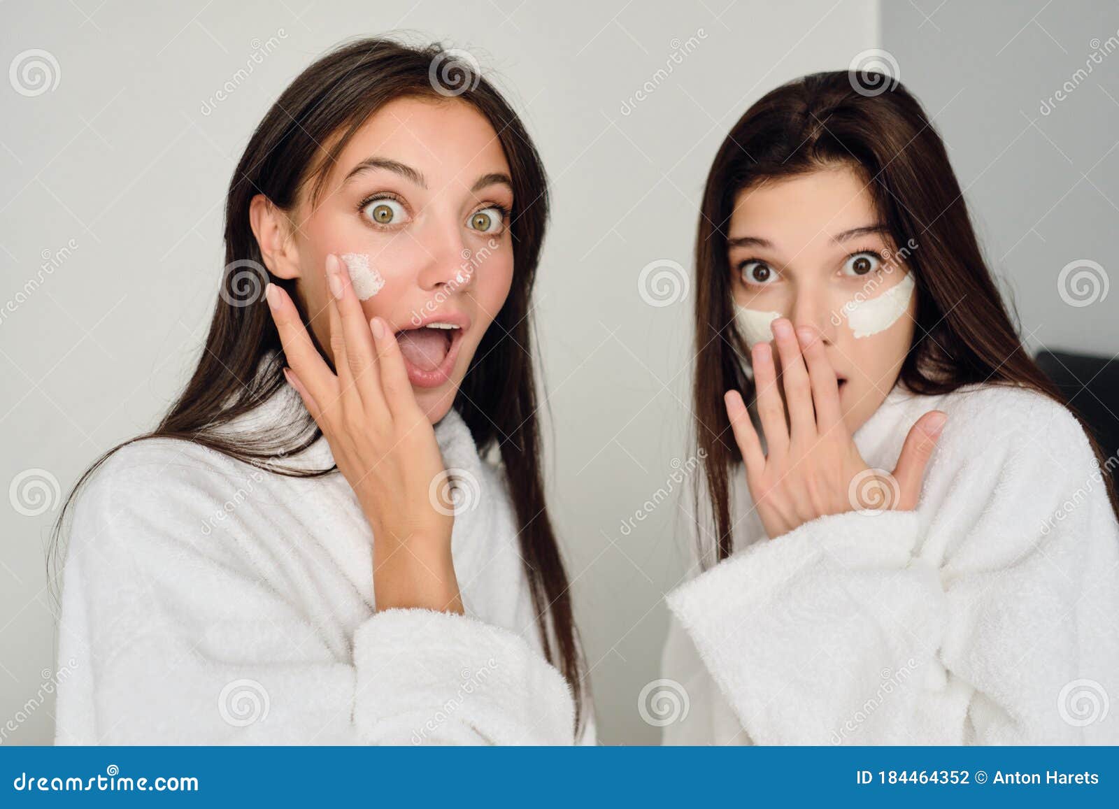 Two Young Attractive Women With Dark Hair In White Bathrobes Sitting On