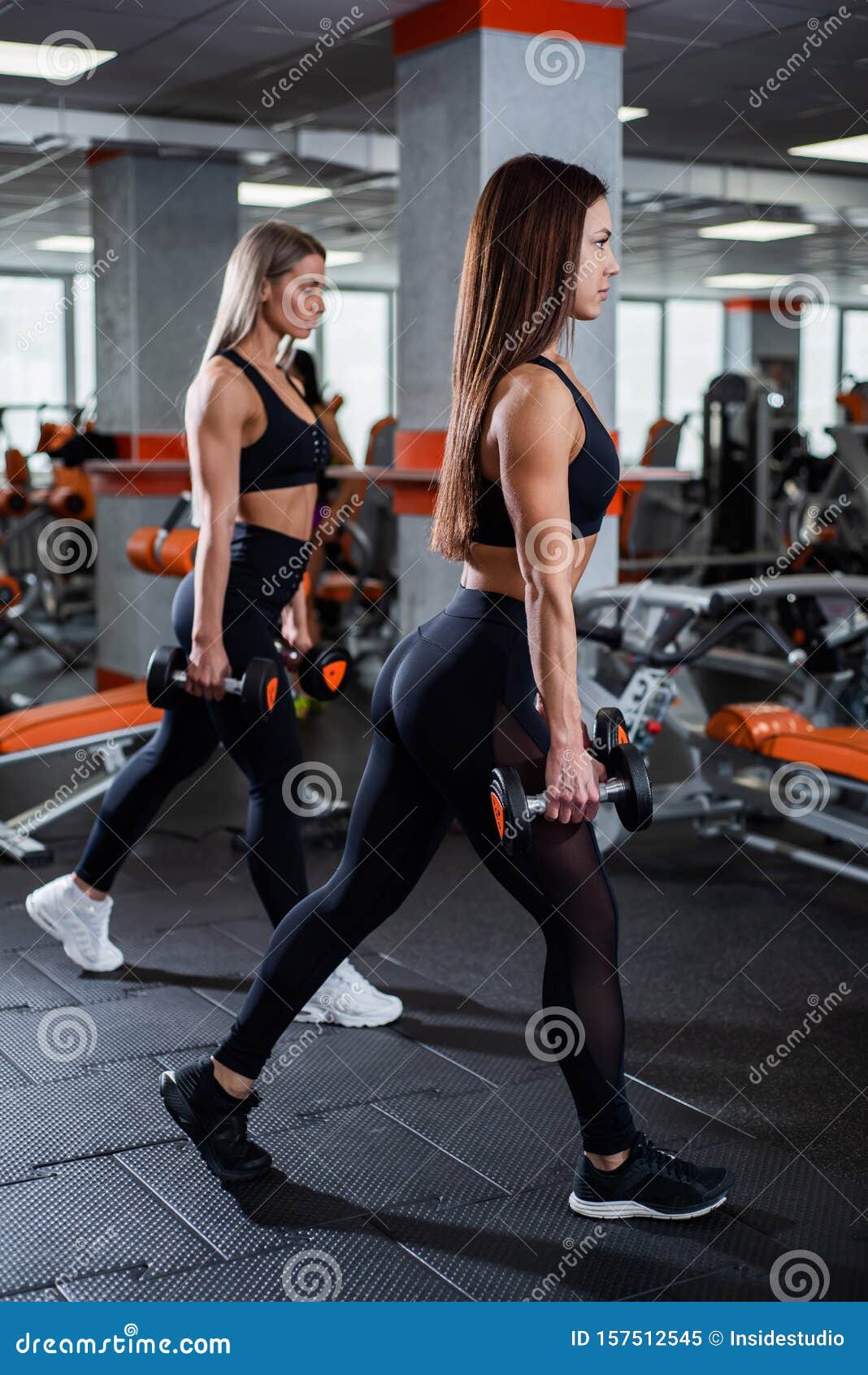 Two Young Beautiful Girls Train Legs And Ass Perform Lunges Forward
