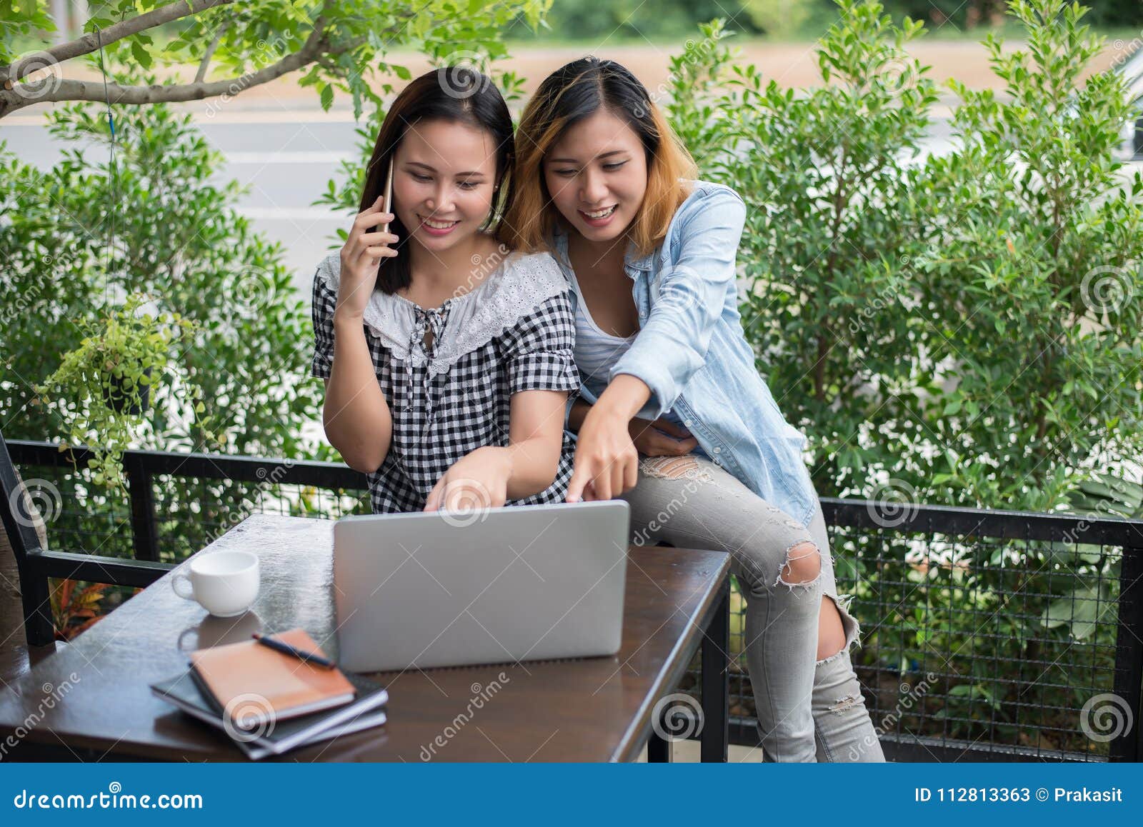 Two Young Beautiful Women Searching Information at Laptop Computer in ...