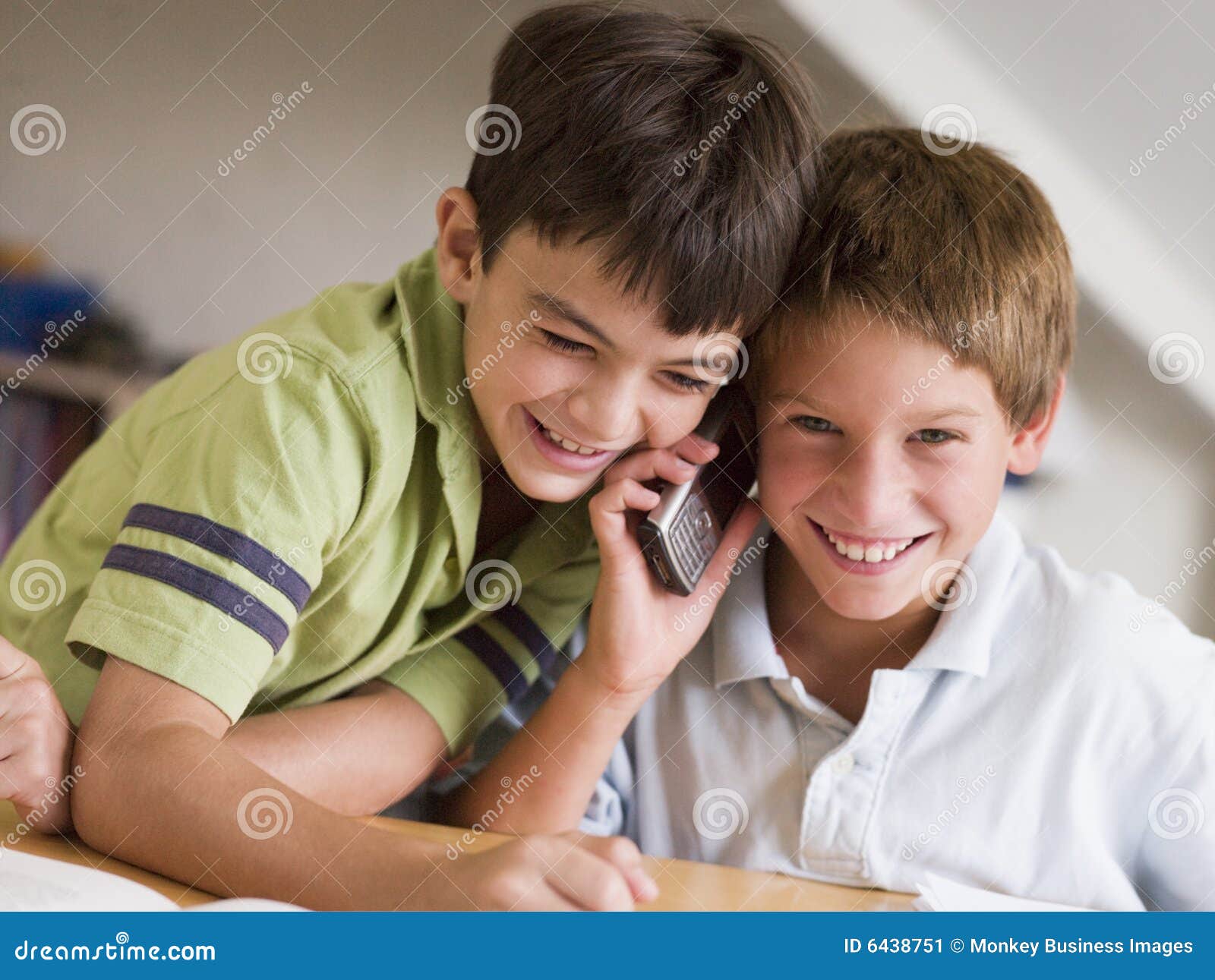 Two Young Boys Calling Someone on a Cellphone Stock Image - Image of ...