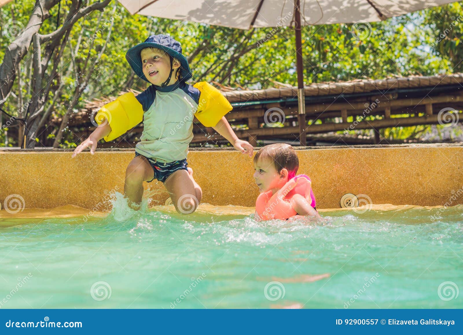Two Young Boys Friends Jumping in the Pool Stock Image - Image of hair ...