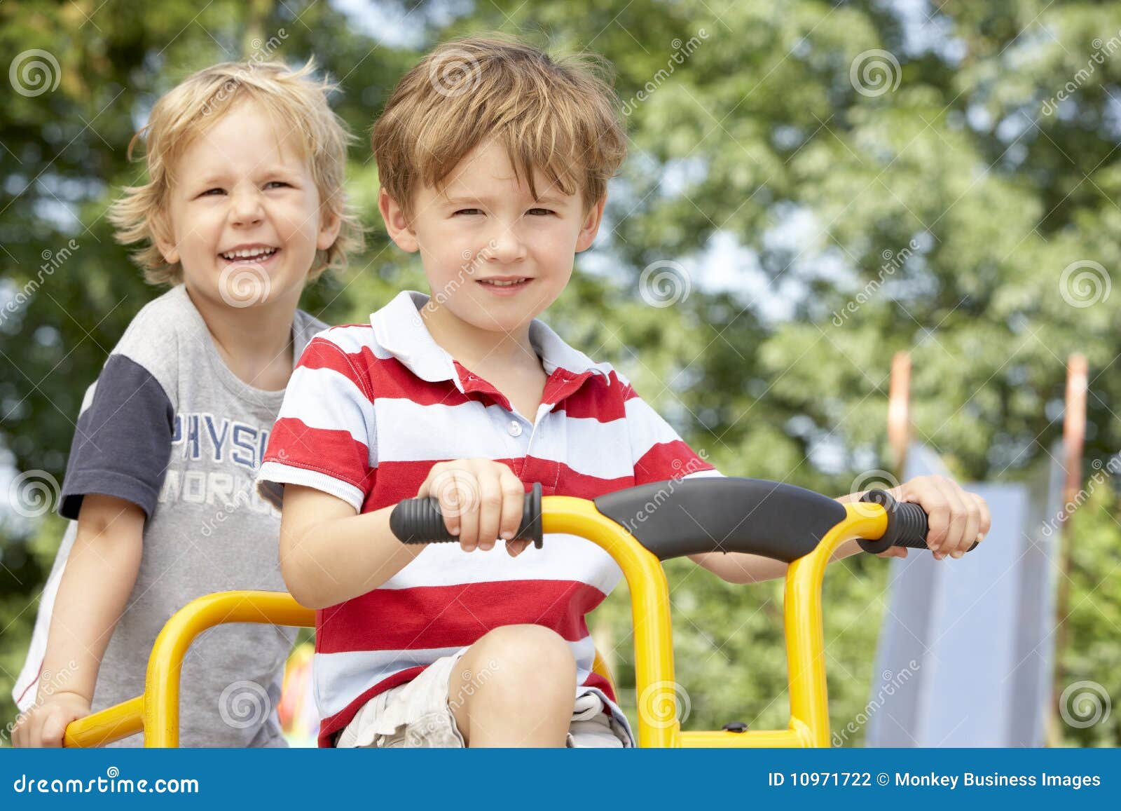 Two Young Boys Playing on Bike Stock Photo - Image of four, playgroup ...