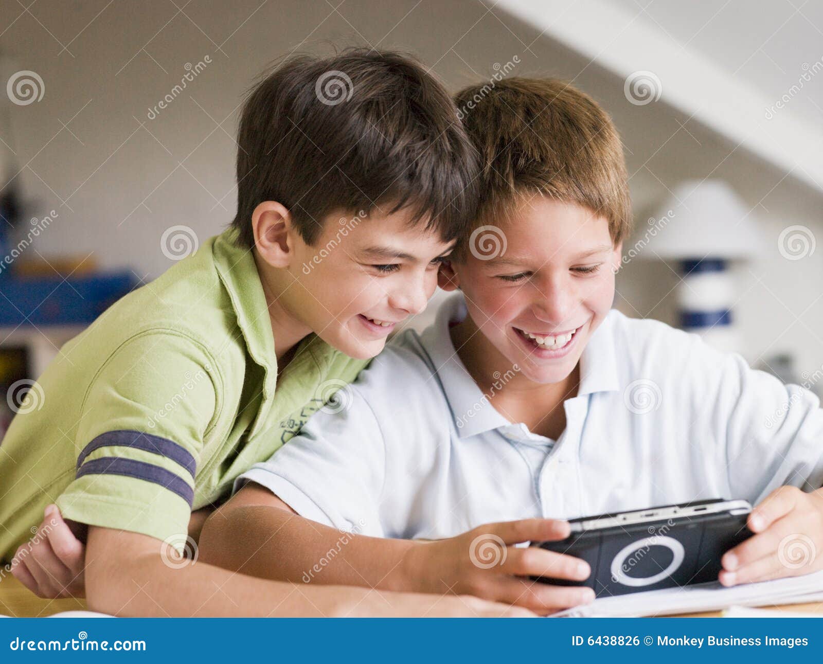 Two Young Boys Playing with a Hand Held Video Game Stock Photo - Image ...