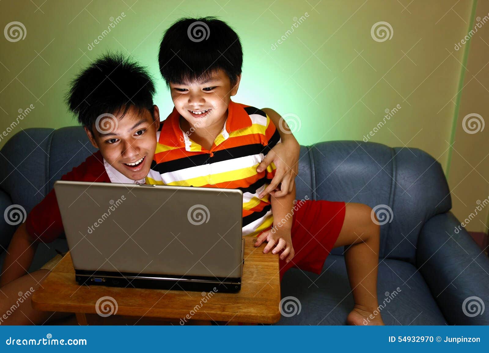 Two Young Boys Using a Laptop Computer and Smiling Stock Photo - Image ...