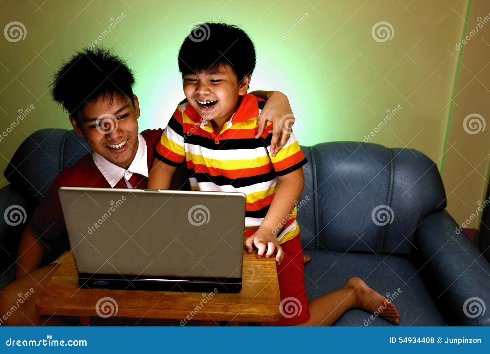 Two Young Boys Using a Laptop Computer and Smiling Stock Photo - Image ...