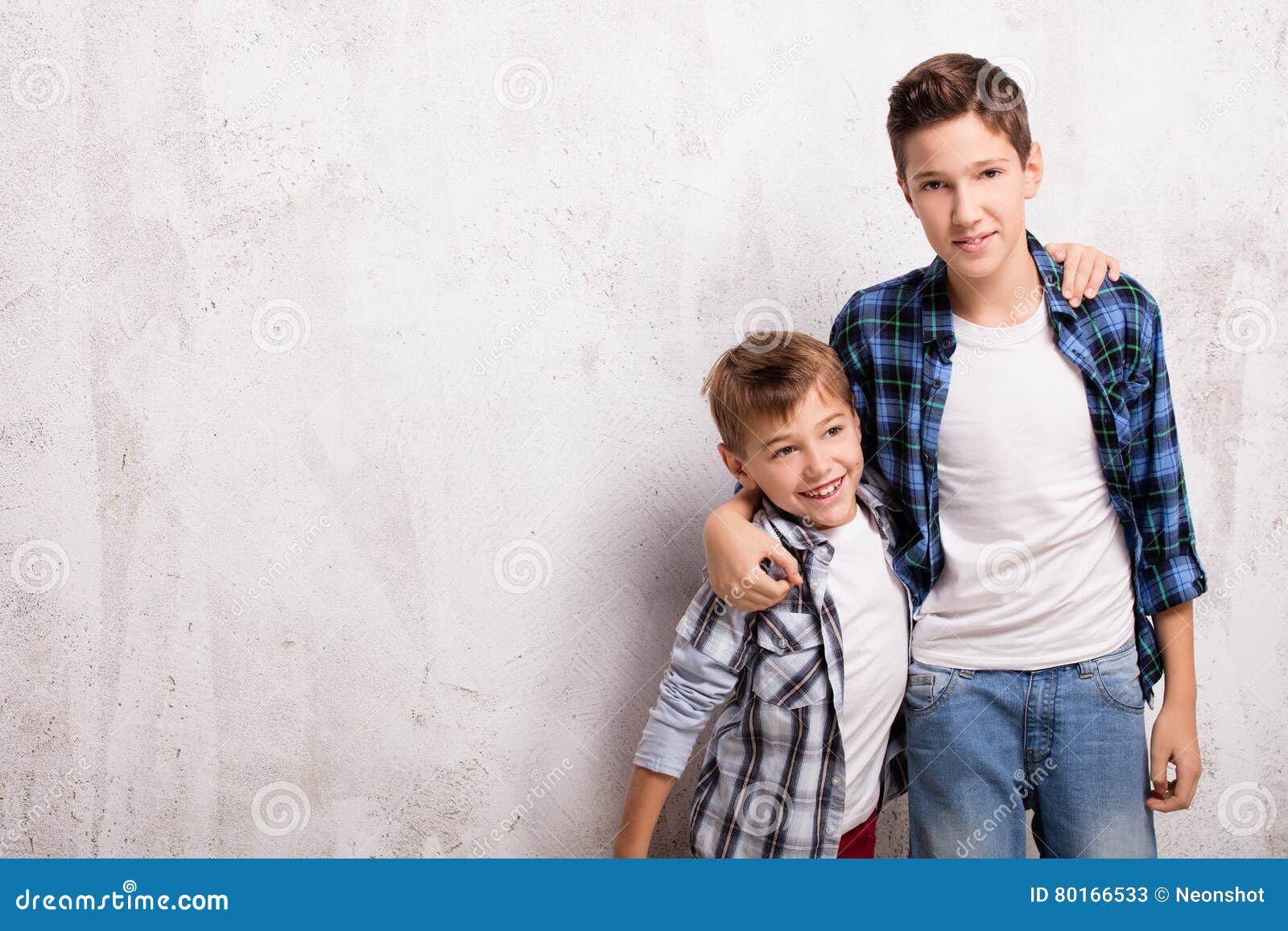 Two young brothers posing. stock image. Image of hugging - 80166533