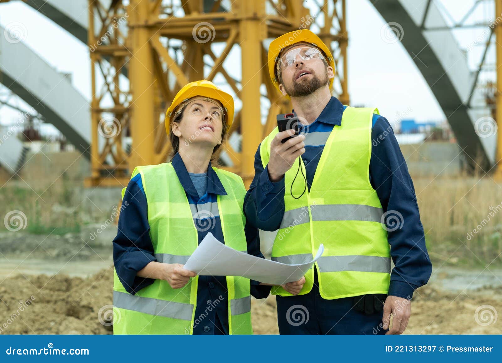 Two Young Builders Looking Upwards Stock Image - Image of building ...