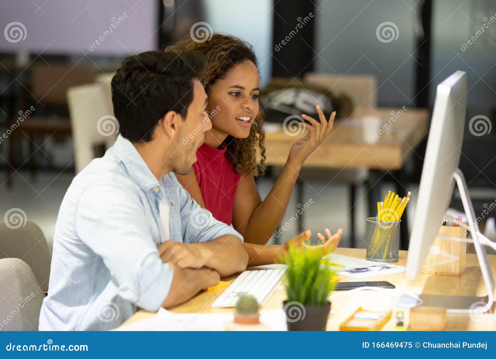 Two Young Business Colleagues Working on Computer, Working Together on ...