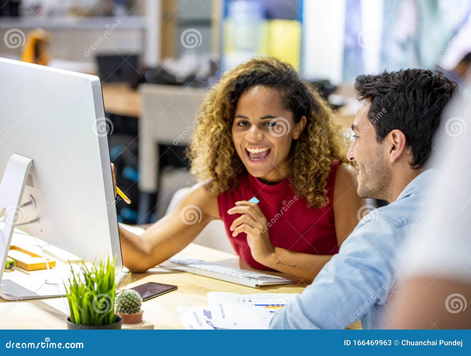 Two Young Business Colleagues Working on Computer, Working Together on ...