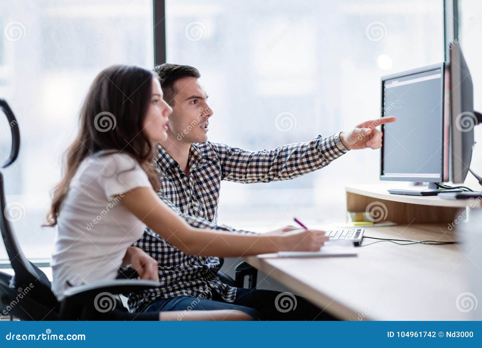 Two Young Business Colleagues Working on Computer Stock Photo - Image ... Two Young Business Colleagues Working on Computer Stock Photo - Image ...