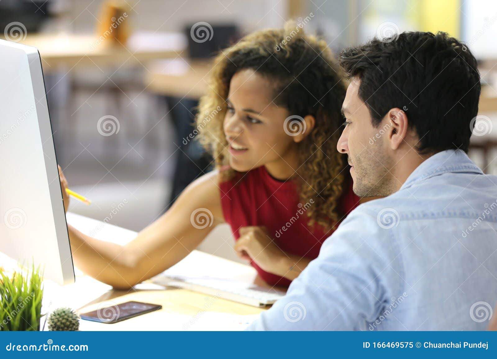 Two Young Business Colleagues Working on Computer, Working Together on ... Two Young Business Colleagues Working on Computer, Working Together on ...