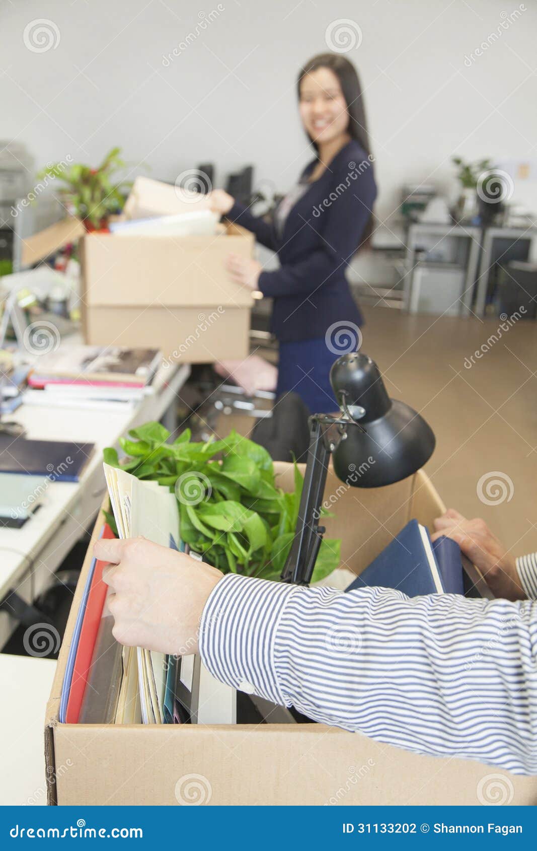 Two Young Business People Carrying Boxes with Office Items Stock Photo ...