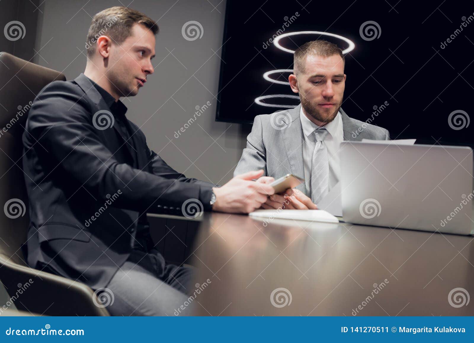 Two Young Business People Discussing Work during a Business ...