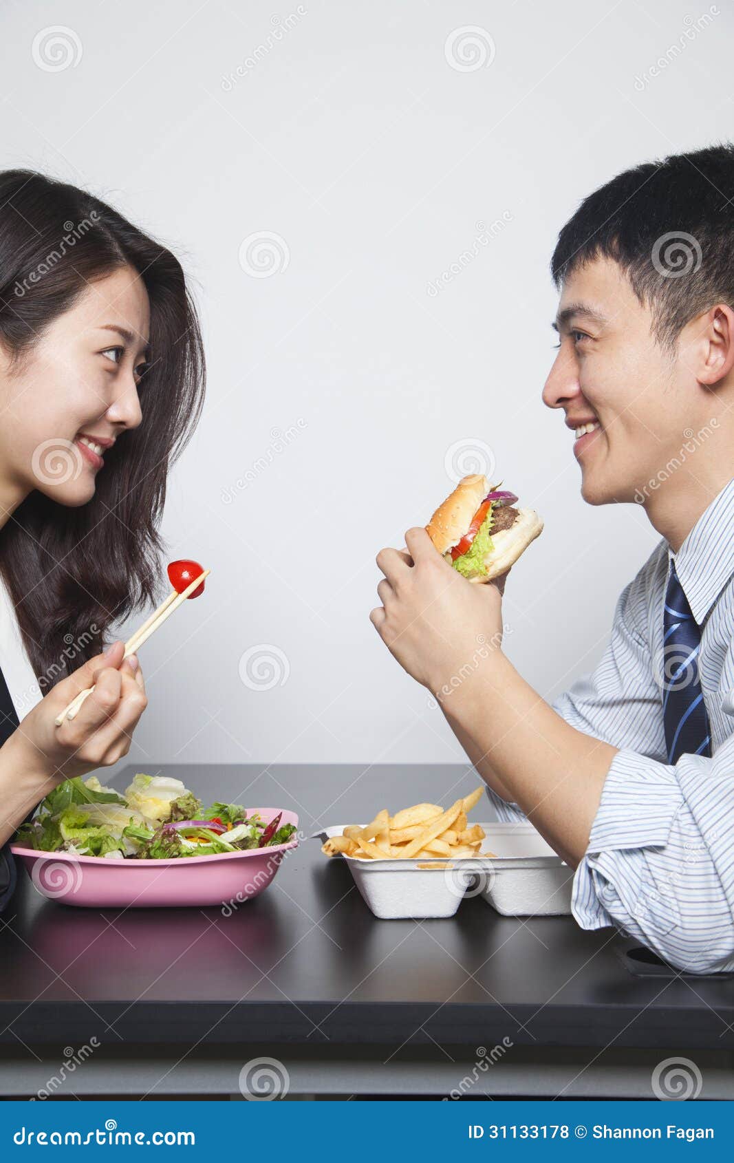 Two Young Business People Eating a Meal Stock Photo - Image of fries ...