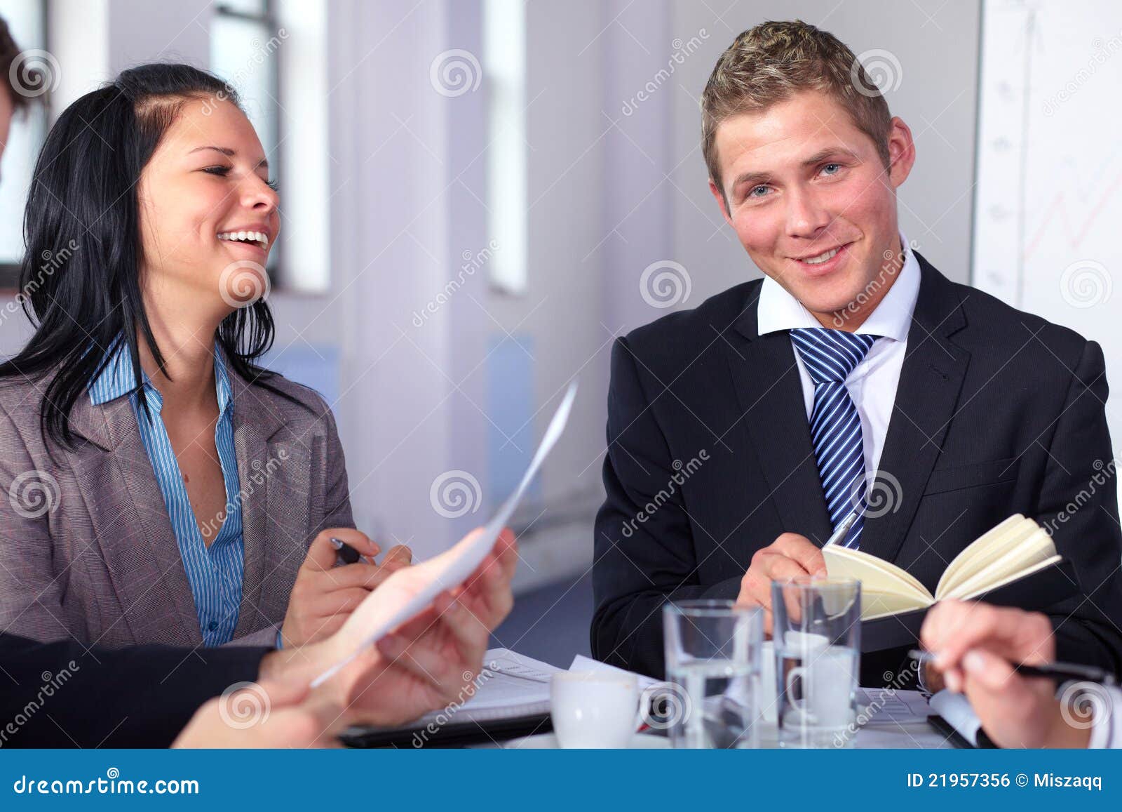 Two Young Business People Sitting at Table Stock Photo - Image of ...