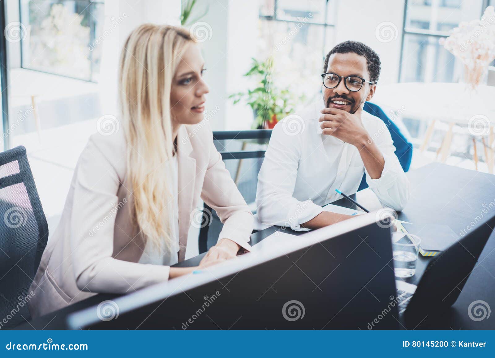 Two Young Business People Working Together in a Modern Office ...