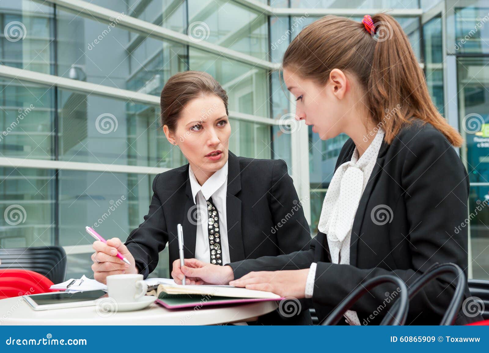 Two young business women stock image. Image of partnership - 60865909