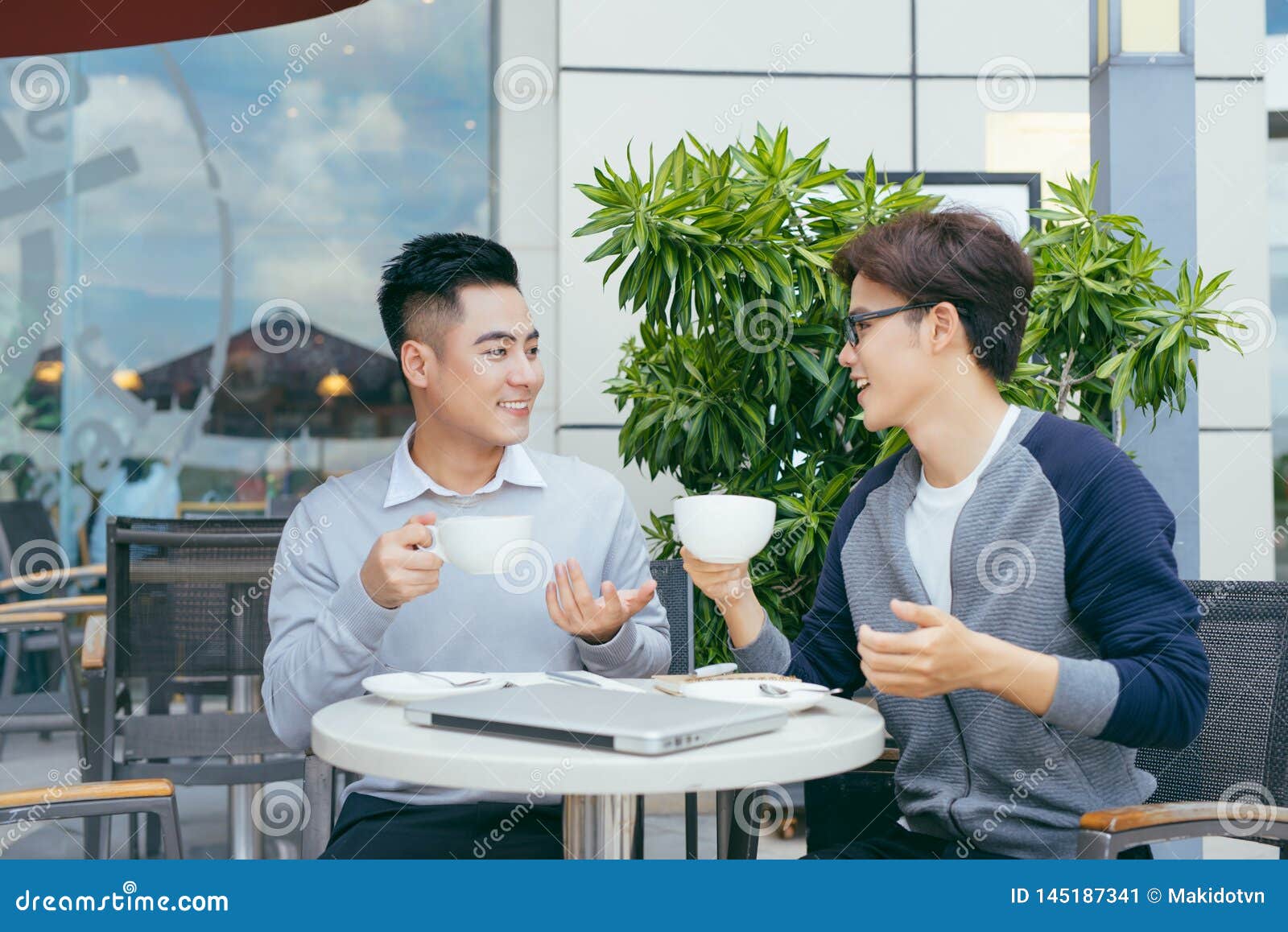 Two Young Businessmen are Chatting in a Coffee Shop. - Image Stock ...
