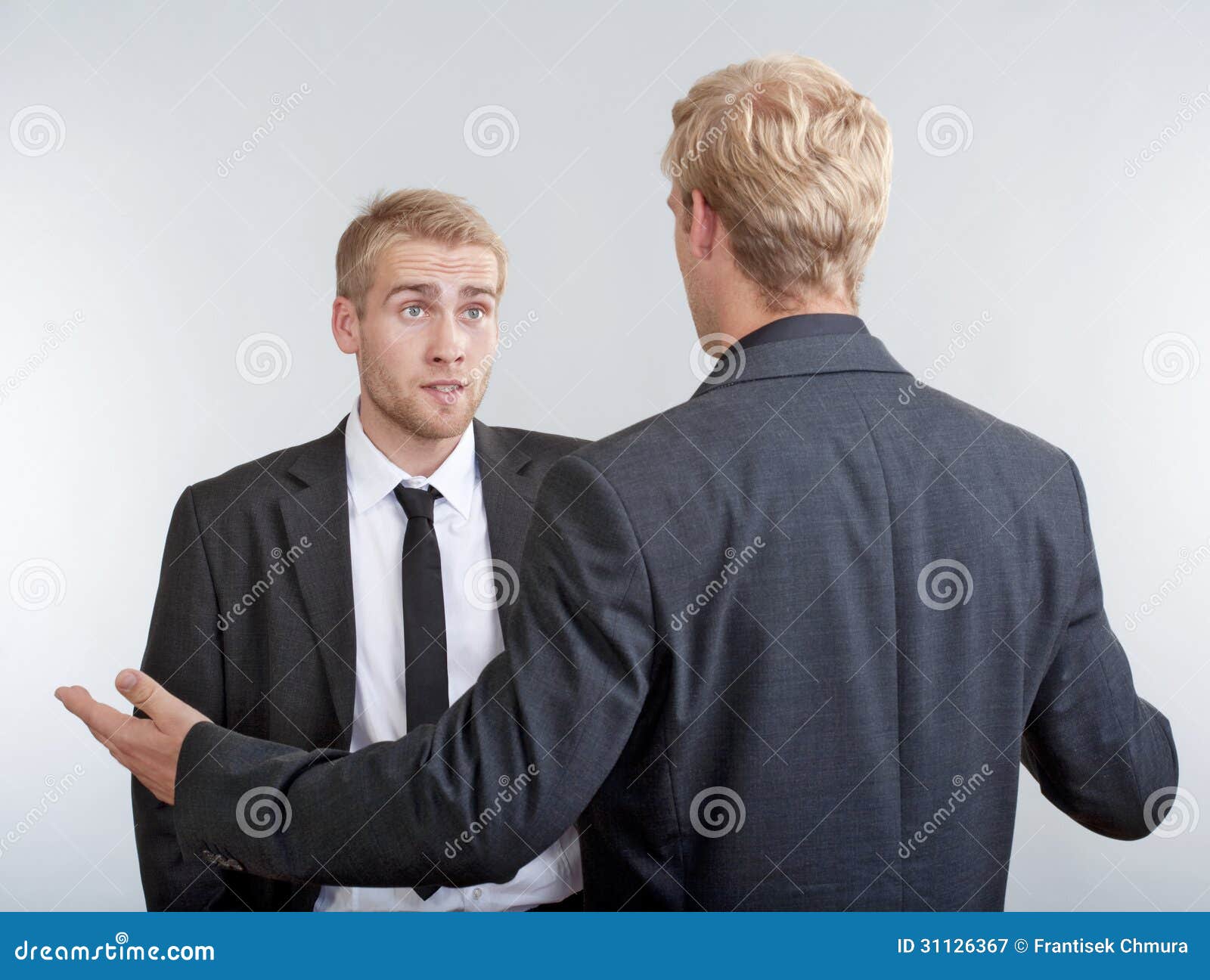Two Young Businessmen Discussing Stock Image - Image of businessman ...