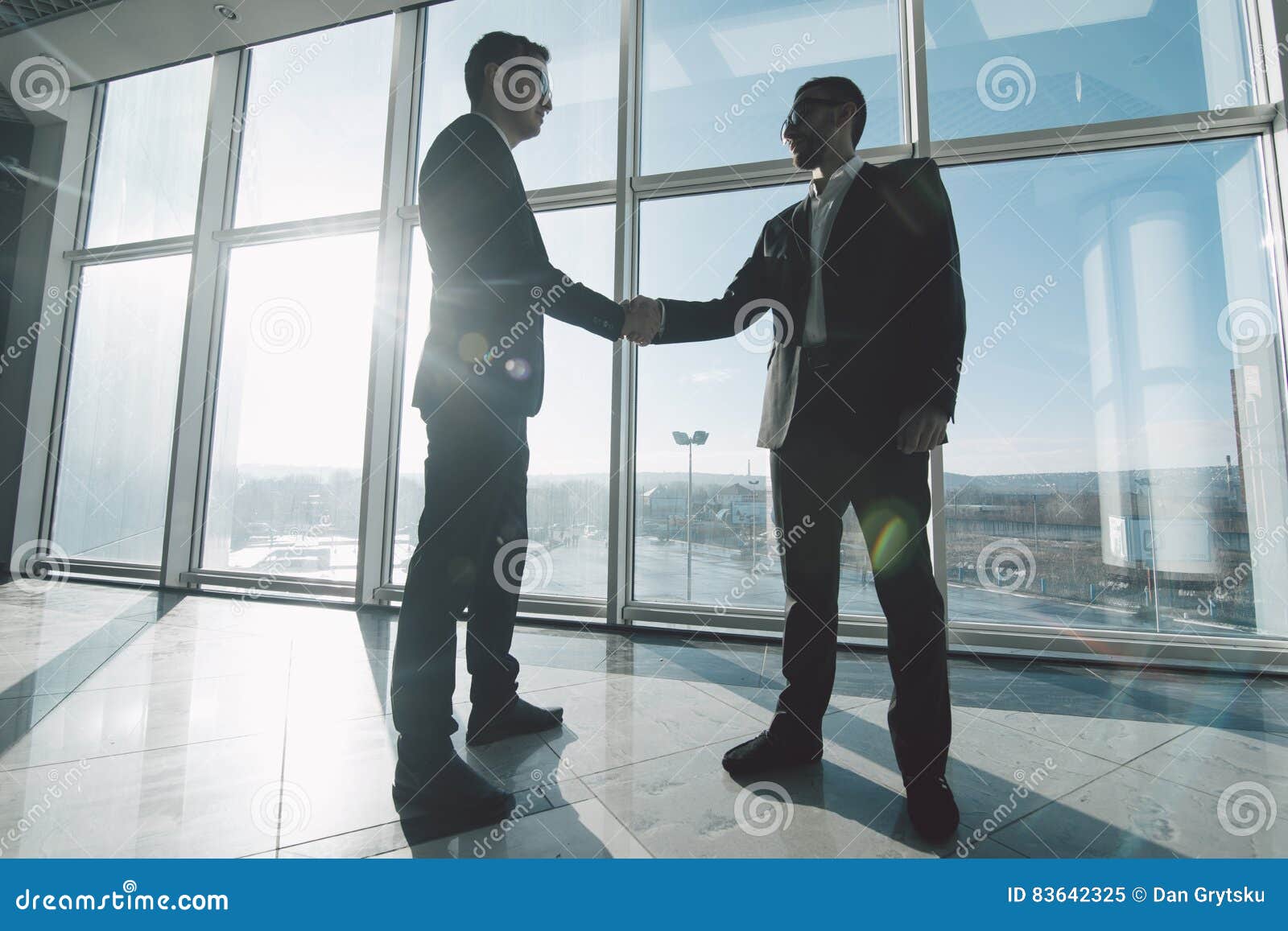 Two Young Businessmen are Standing in Modern Office Stock Image - Image ...