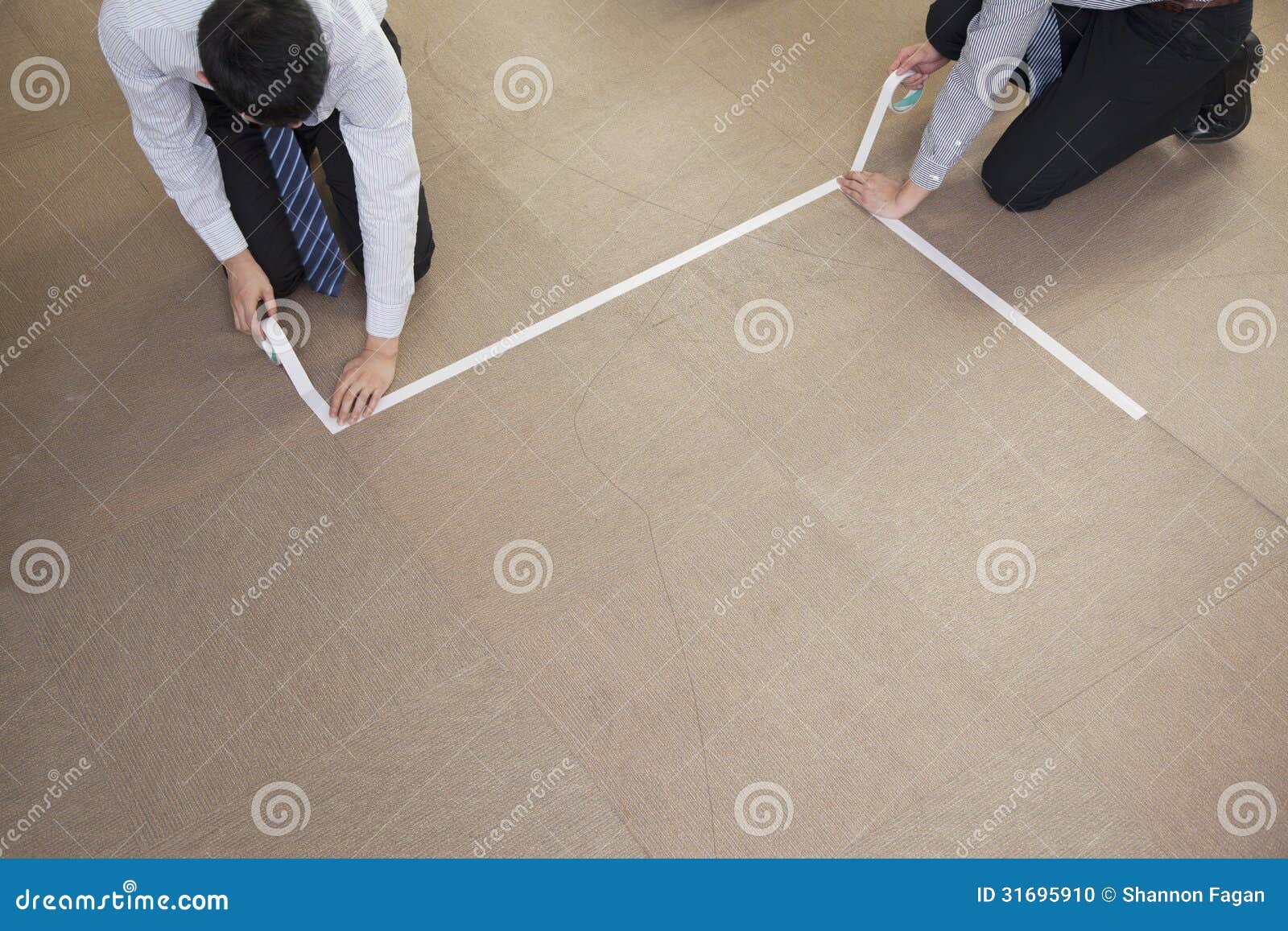 Two Young Businessmen Taping Up the Floor in the Office Stock Photo ...