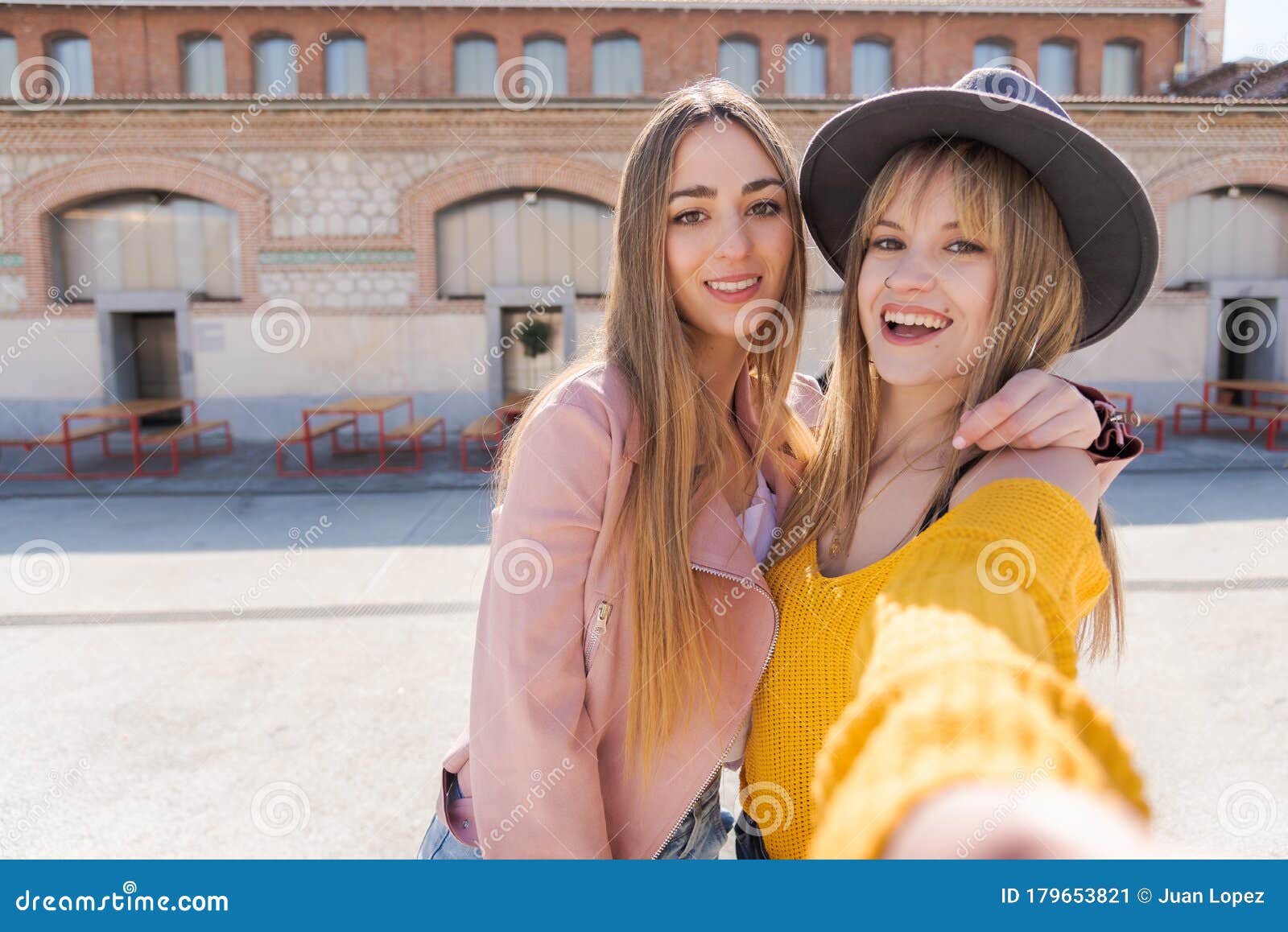 Two Young Girls Smiling and Happy on the Street in the Sunlight Stock ... Two Young Girls Smiling and Happy on the Street in the Sunlight Stock ...