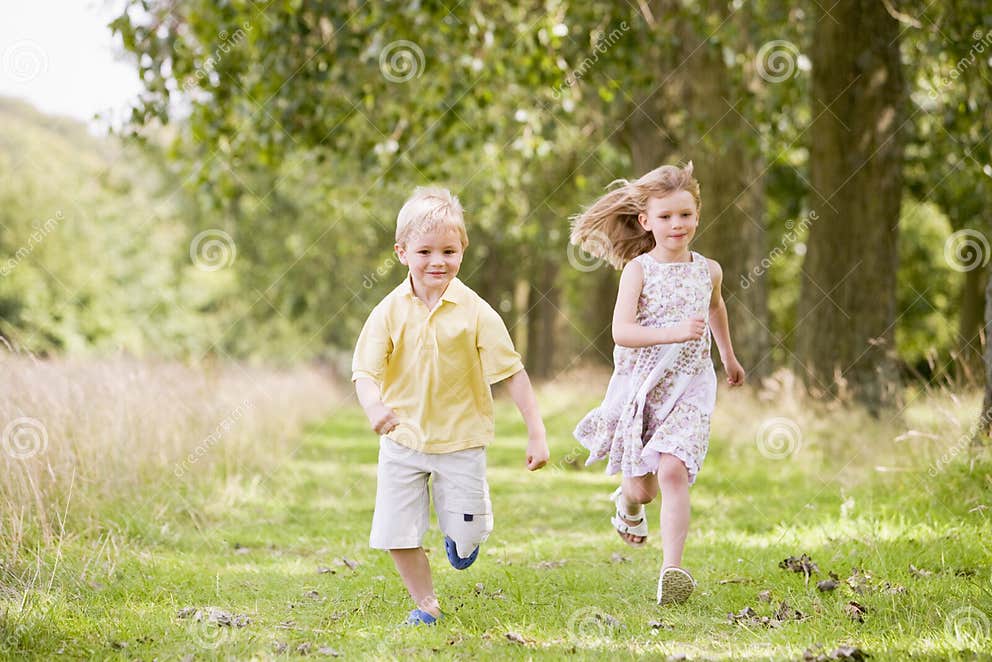 Two Young Children Running on Path Smiling Stock Image - Image of ...